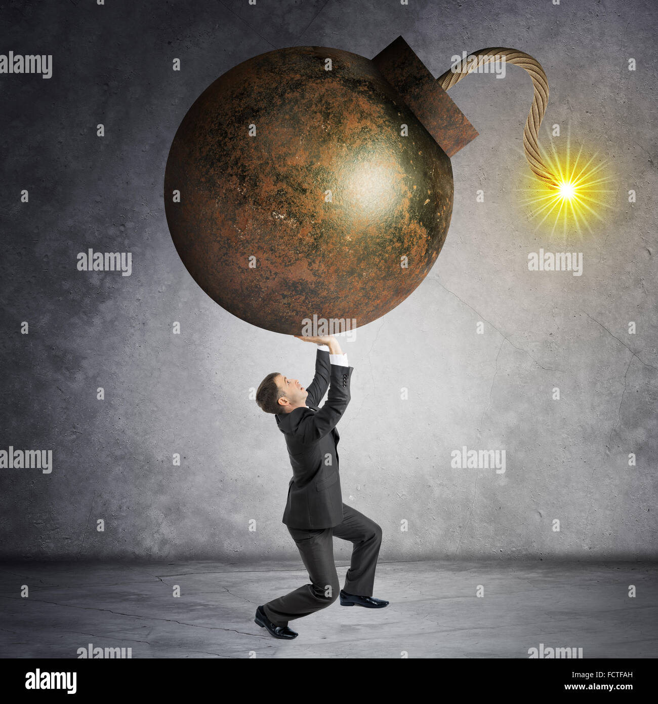 Businessman holding heavy bomb Stock Photo - Alamy