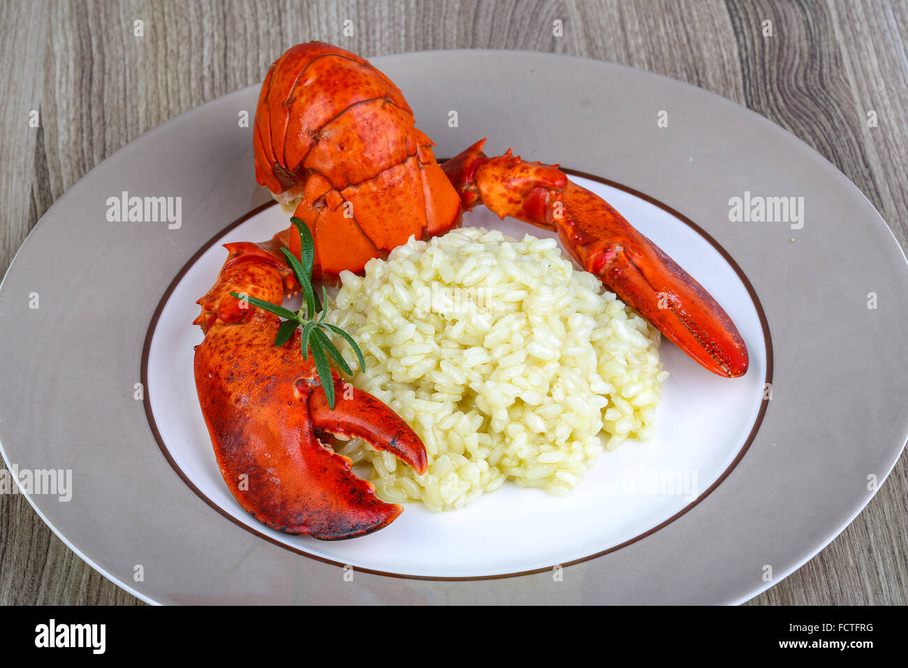 Delicous Risotto with lobster served rosemary and parmesan Stock Photo ...