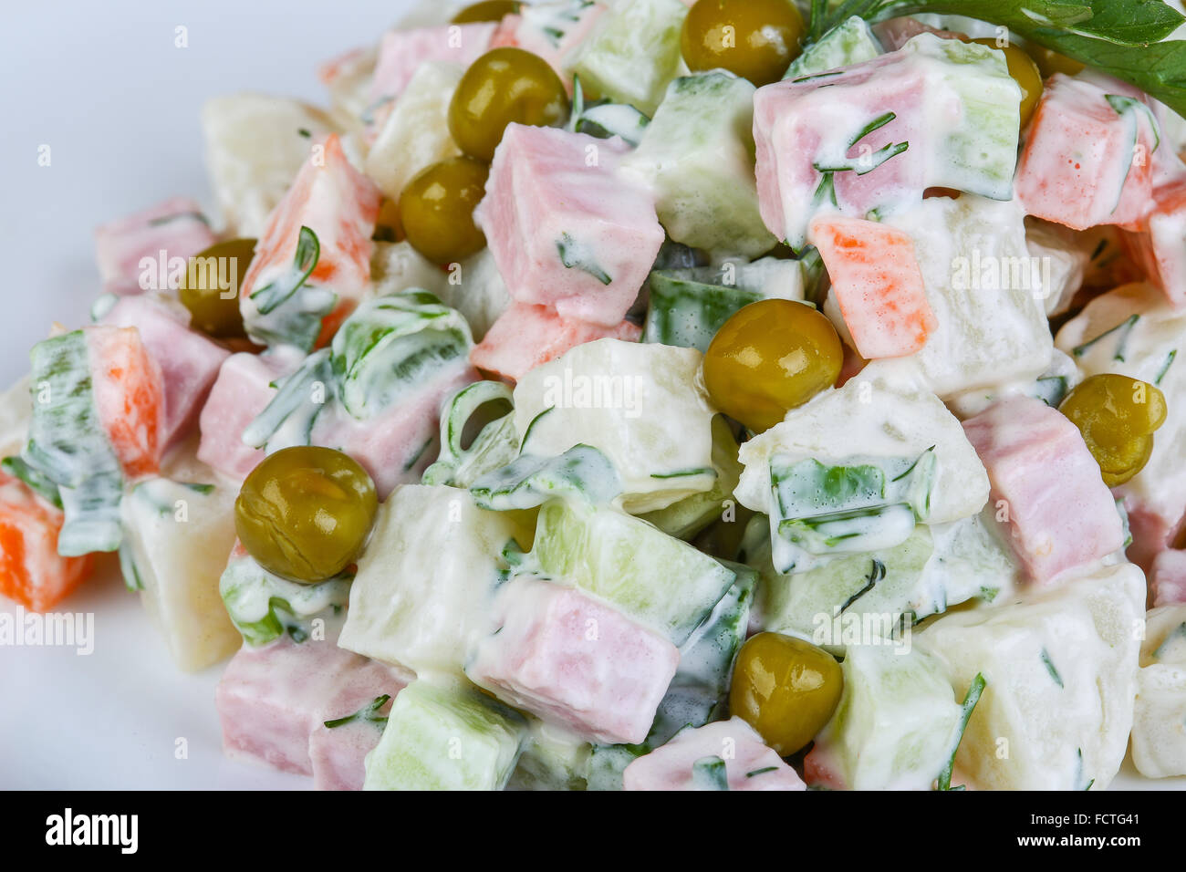 Traditional cuisine - Russian salad with parsley and sausages Stock ...