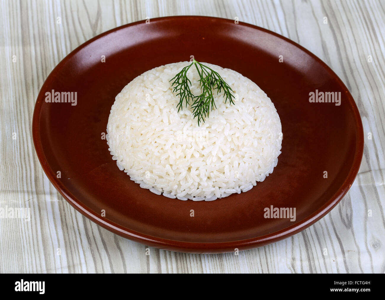 Hot Steamed rice with dill branch on the brown plate Stock Photo - Alamy