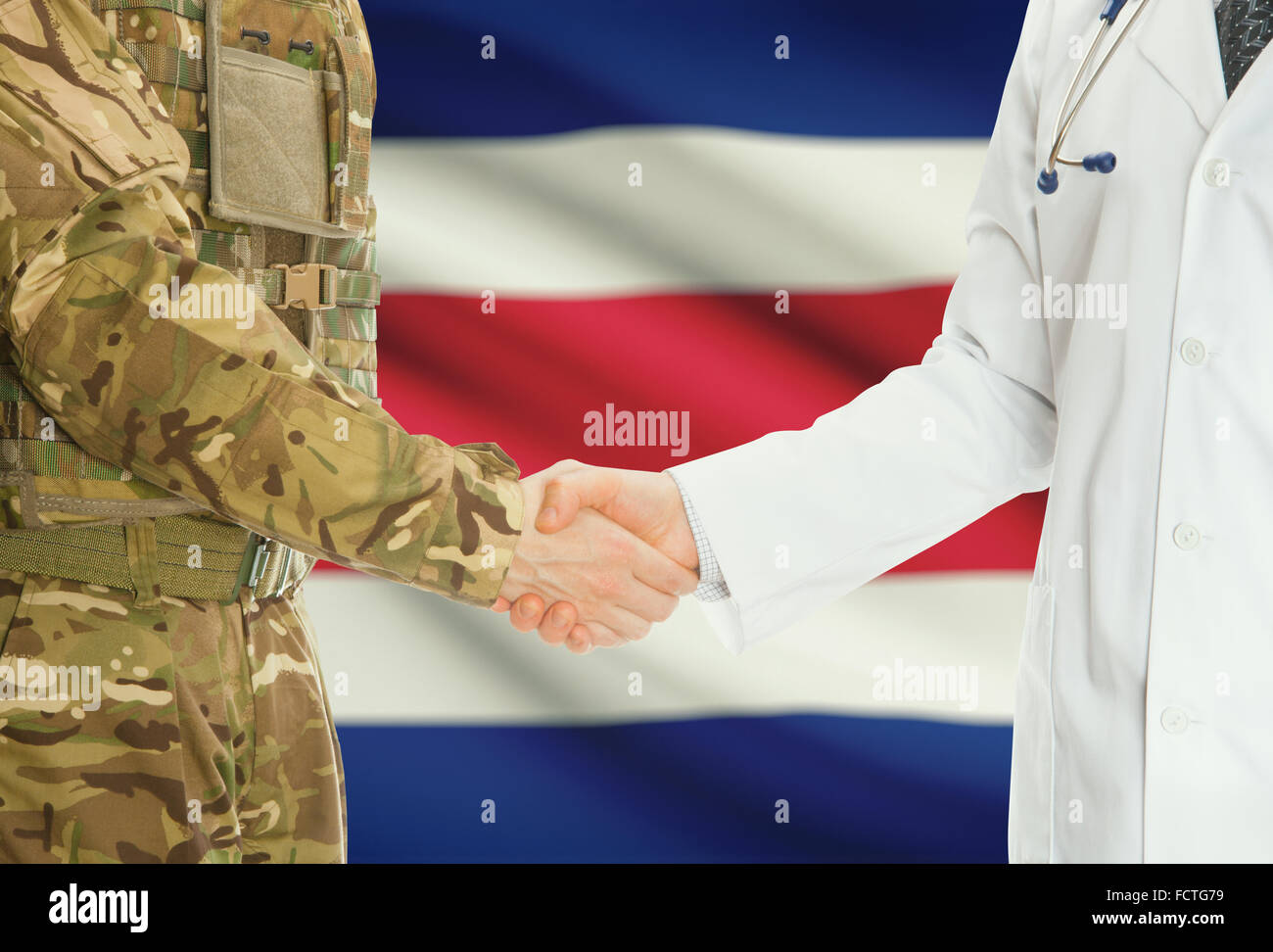 Soldier in uniform and doctor shaking hands with national flag on ...