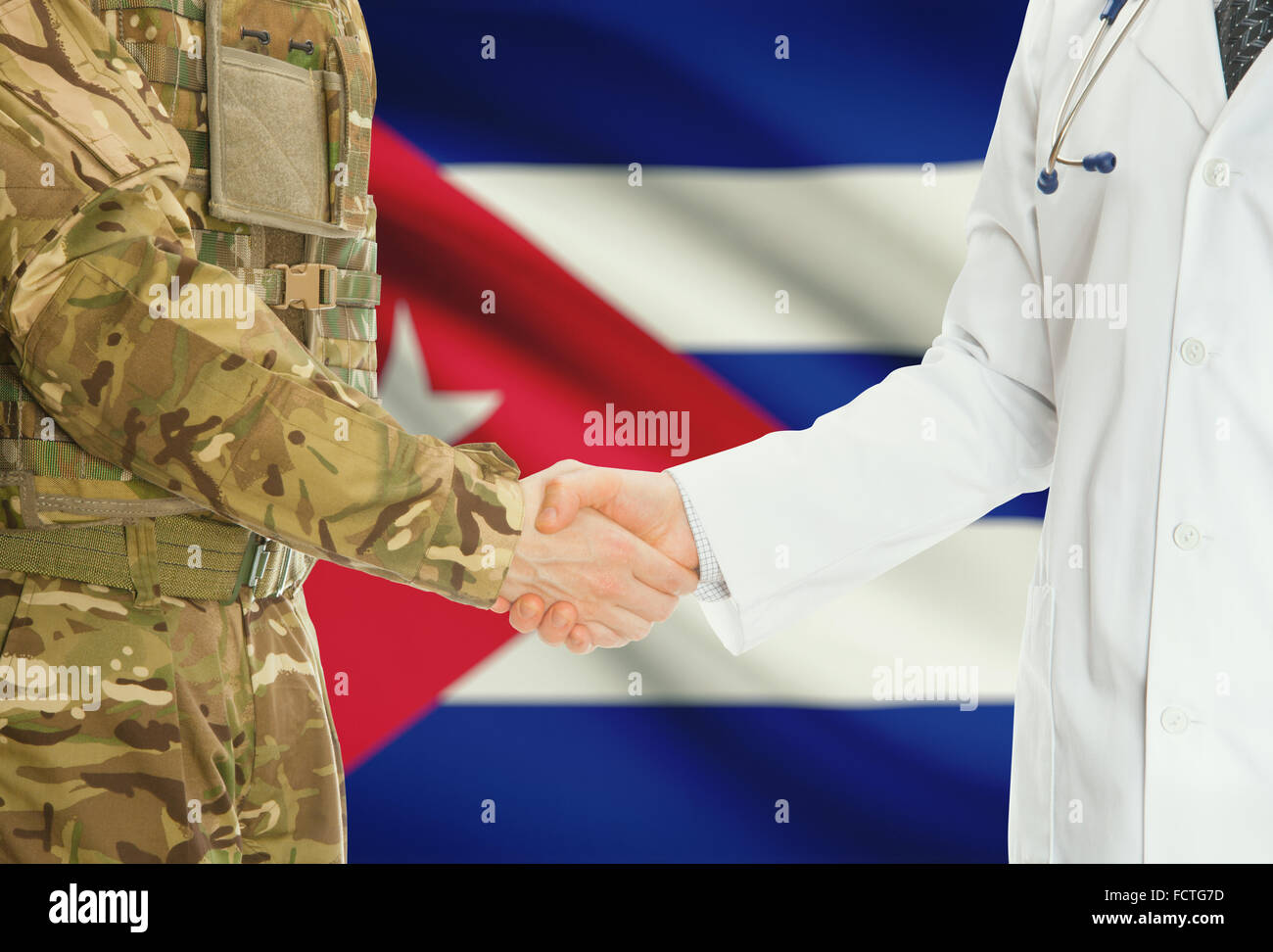 Soldier in uniform and doctor shaking hands with national flag on ...