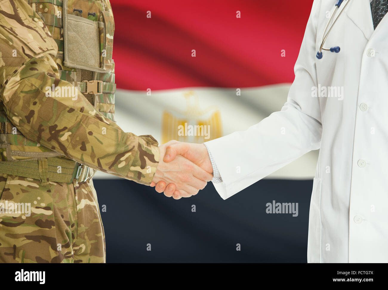 Soldier in uniform and doctor shaking hands with national flag on ...
