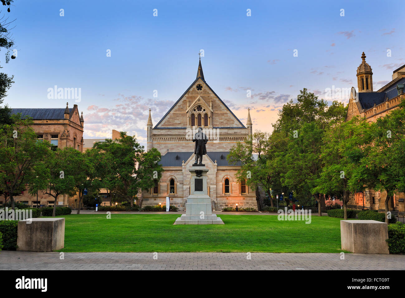 facade of classical gothic building and monument statue of University ...