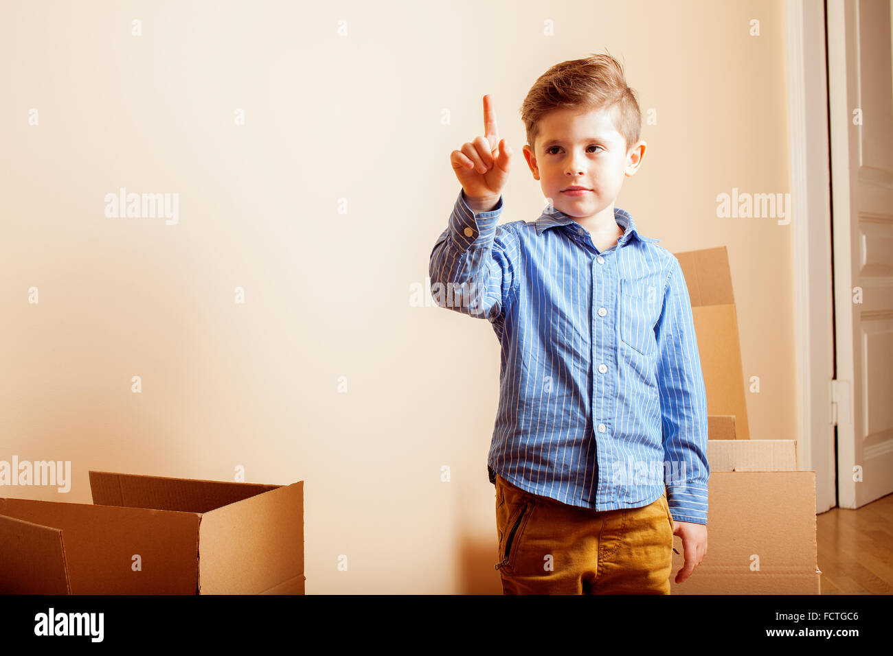 little cute boy in empty room, remoove to new house. home alone emong ...