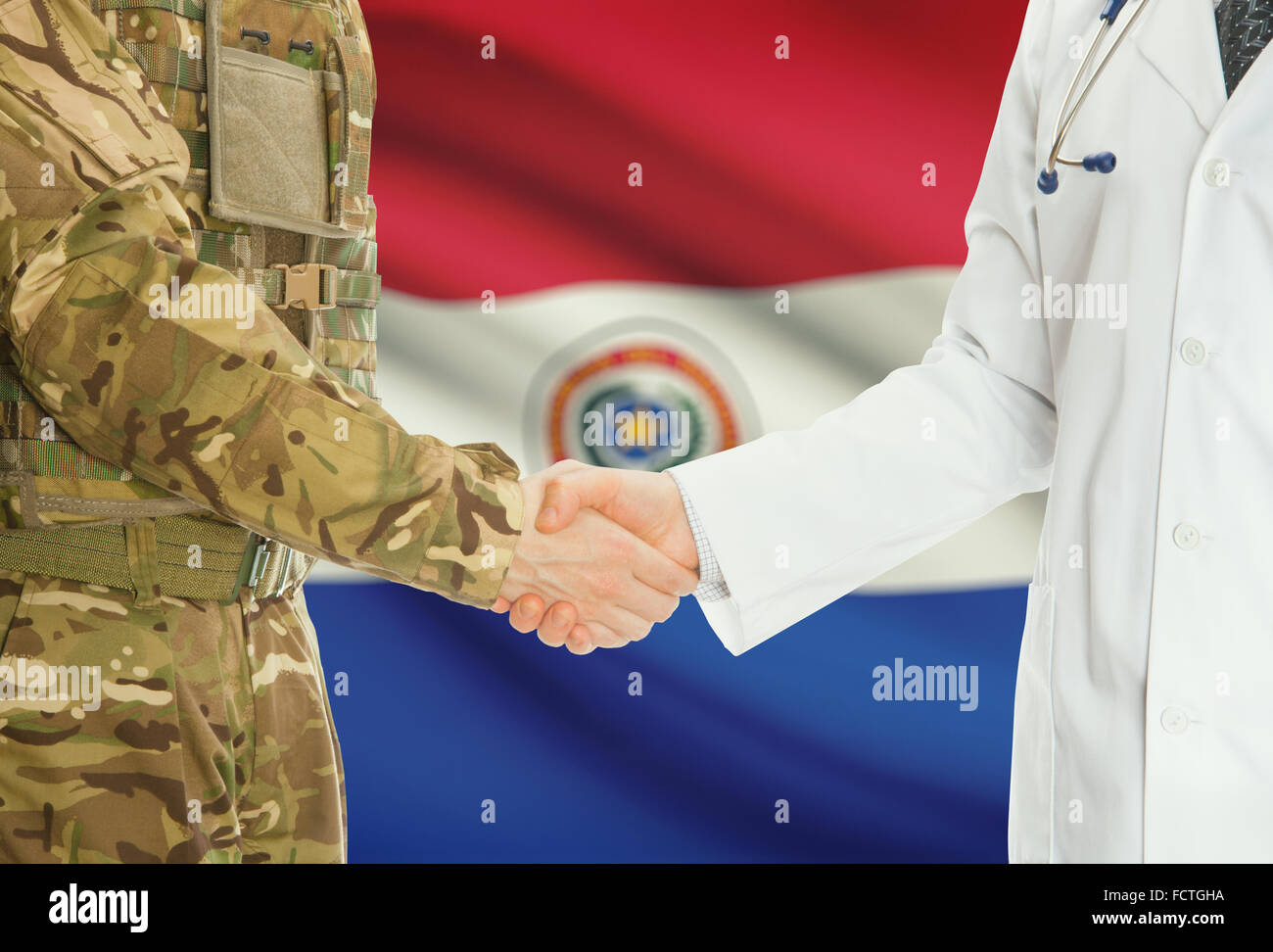 Soldier in uniform and doctor shaking hands with national flag on ...