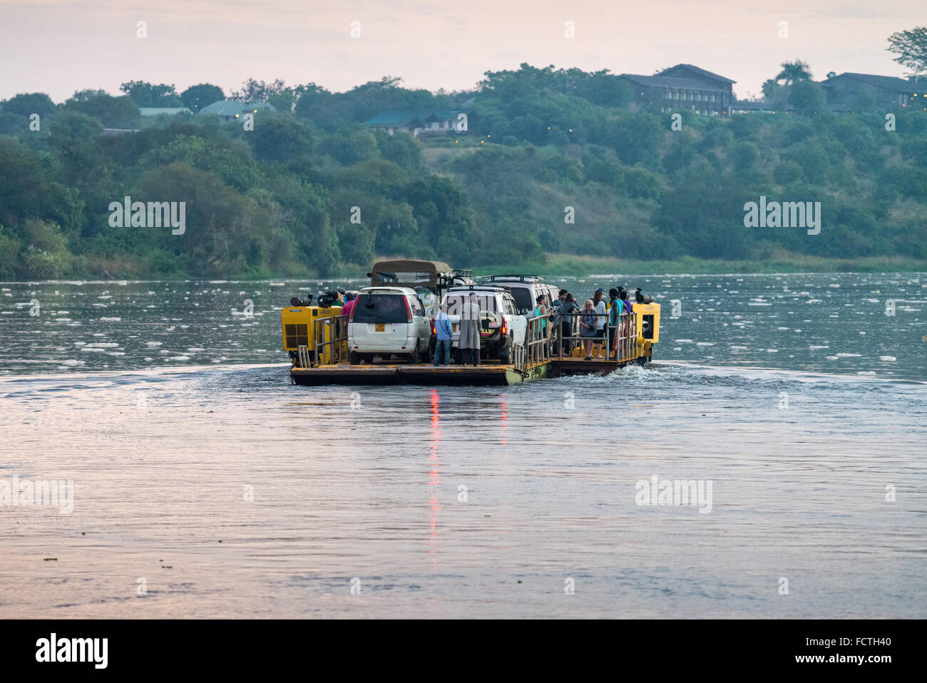 Ferry carrying vehicles and passengers across the River Nile near ...