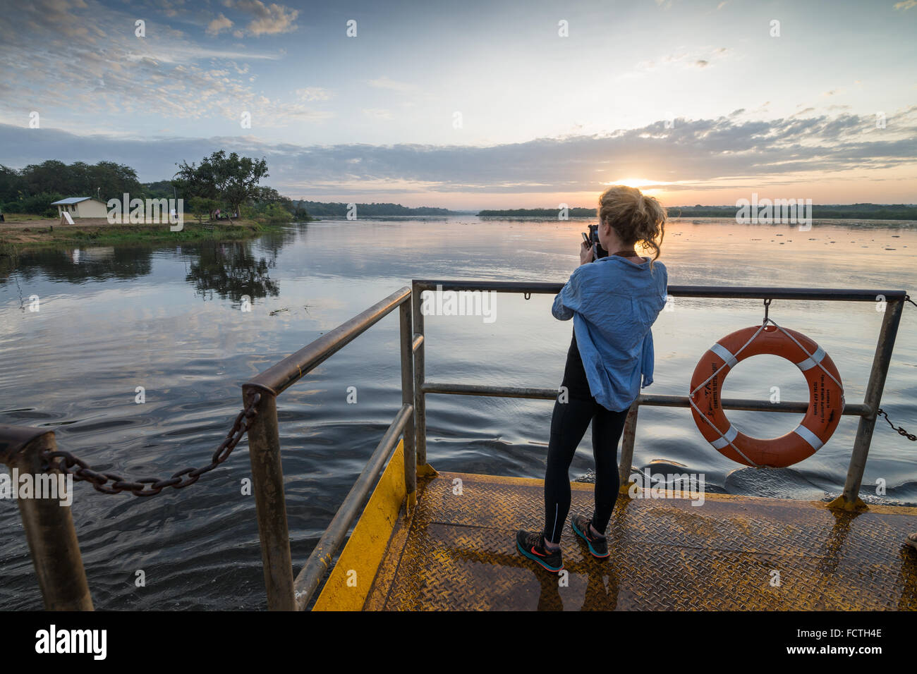 Ferry carrying vehicles and passengers across the River Nile near ...
