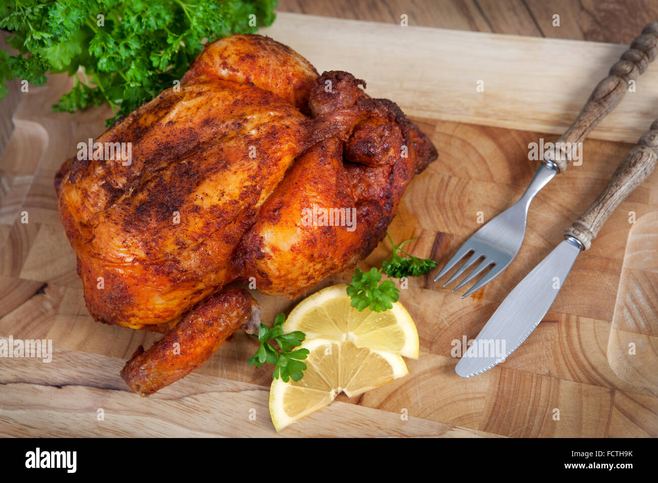 a whole roast chicken on a cutting board with side dishes Stock Photo ...