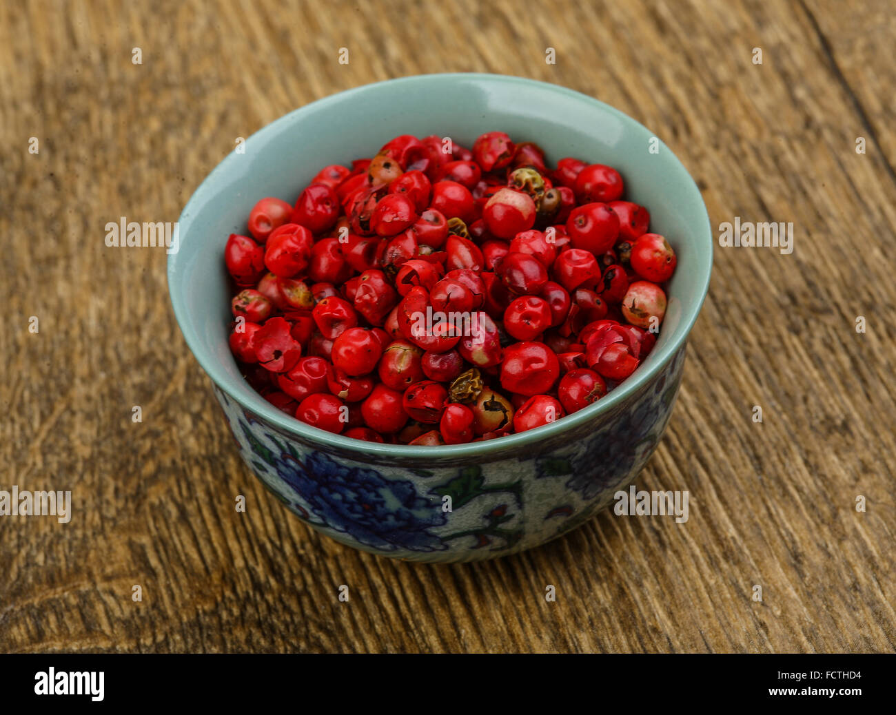 Dry Rose pepper corn on the wood background Stock Photo - Alamy