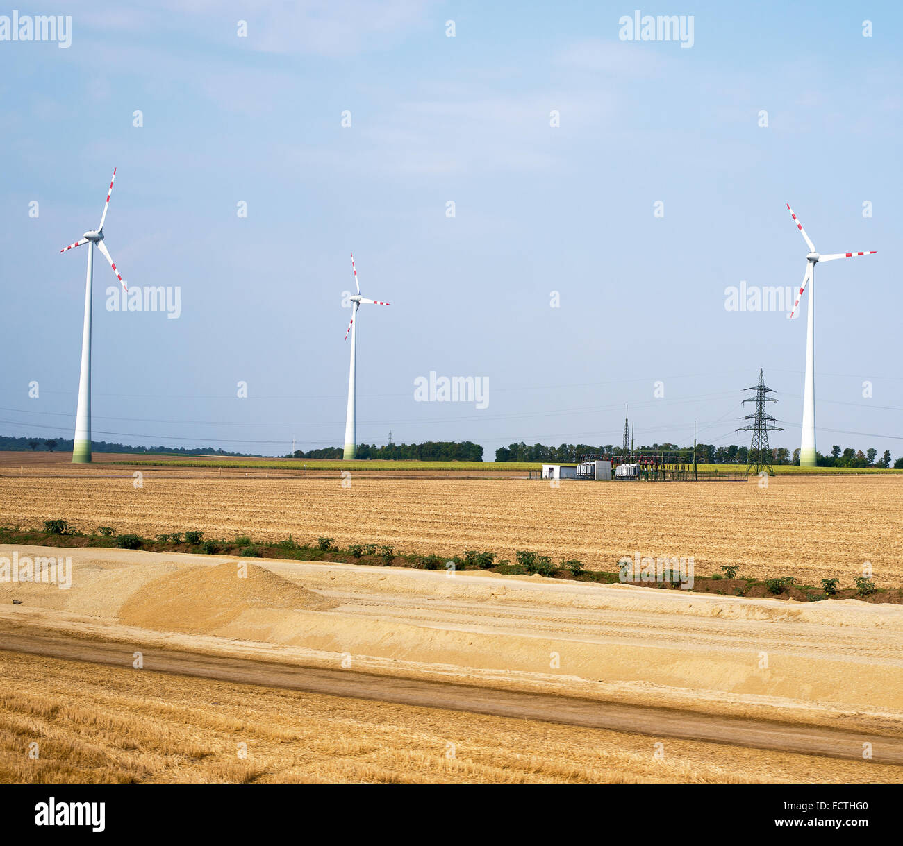 Wind farms on field Stock Photo - Alamy
