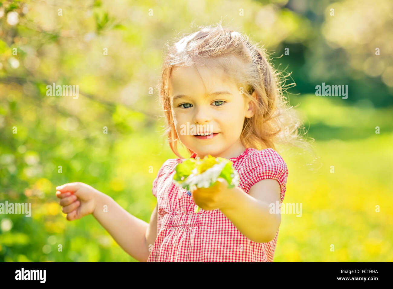 Happy little girl in spring sunny park Stock Photo - Alamy