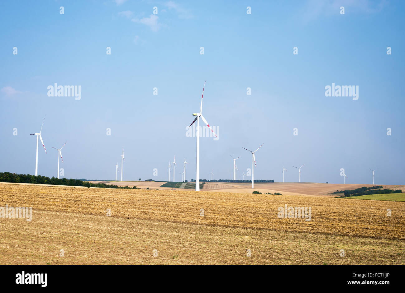 Wind farms on field Stock Photo - Alamy