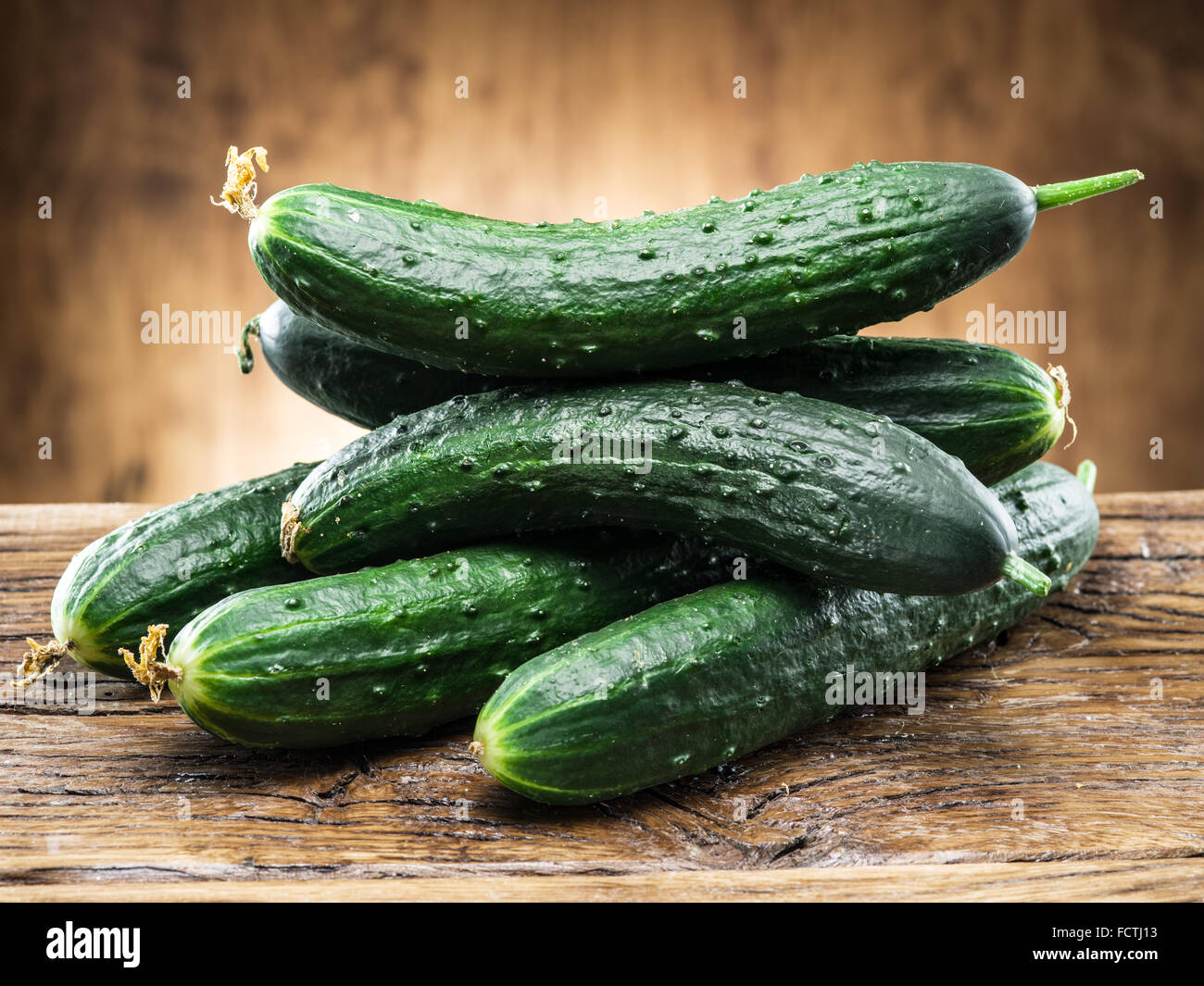 Cucumbers on the wooden table Stock Photo - Alamy