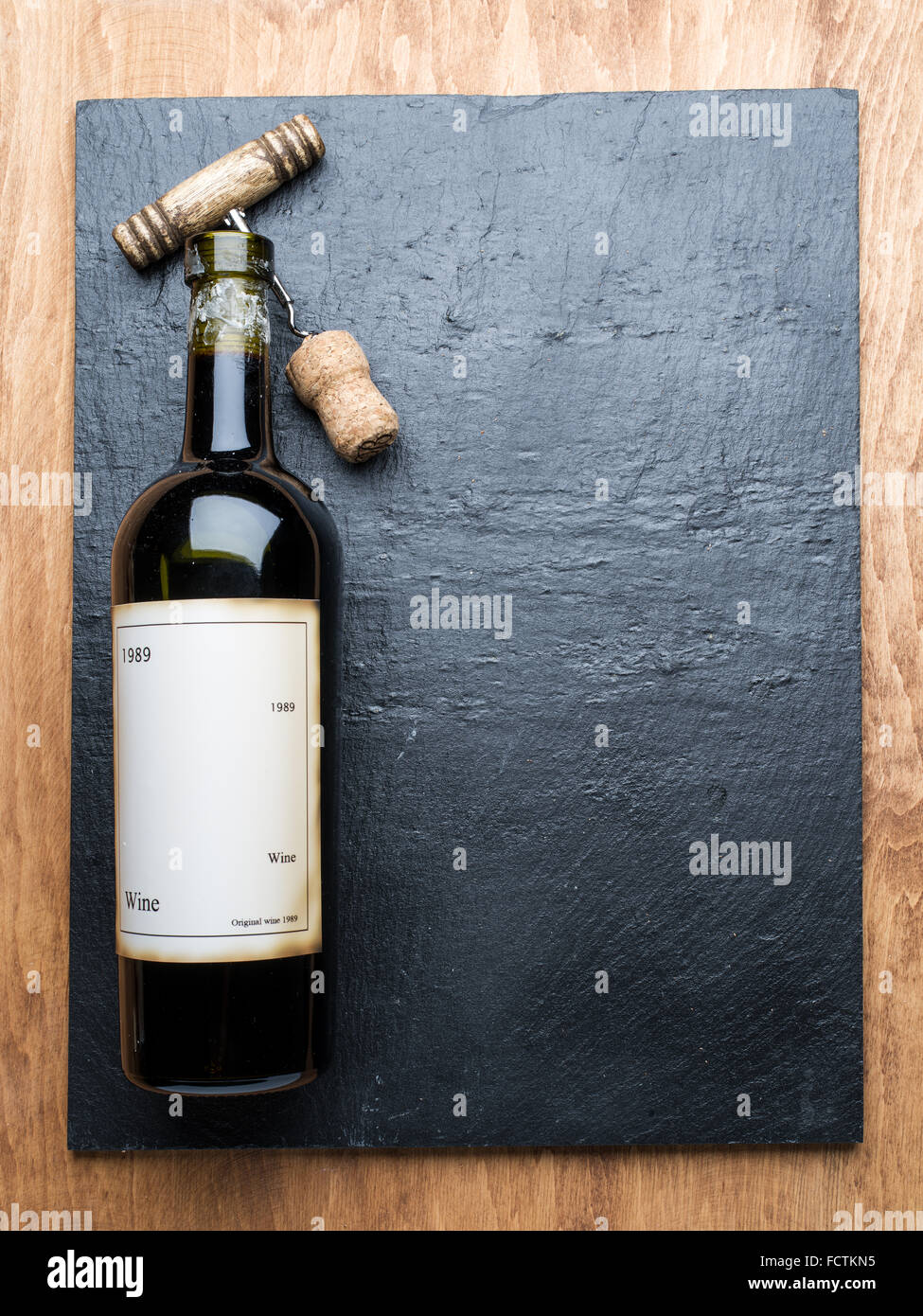 Wine bottle and corkscrew on the graphite board Stock Photo - Alamy