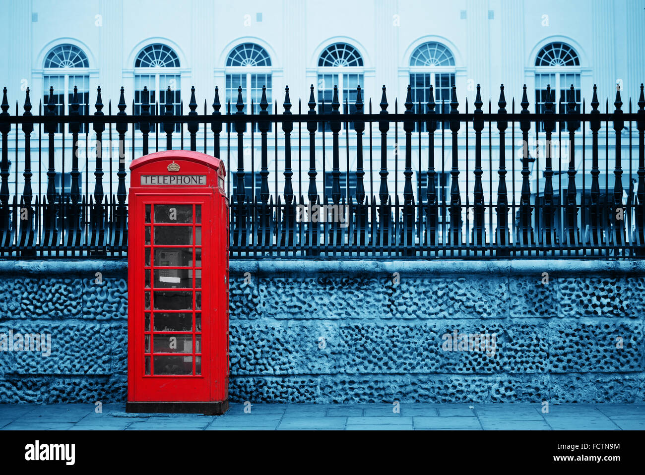 Red telephone box in street with historical architecture in London ...