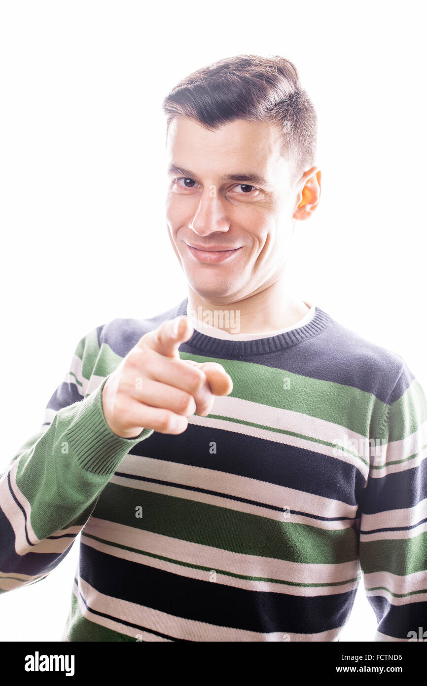 Portrait of a smart serious young man standing against white background ...