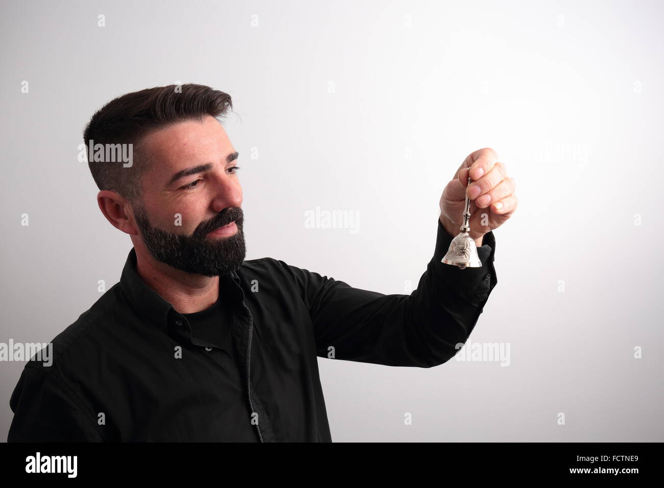 Man dressed in black ringing Stock Photo - Alamy
