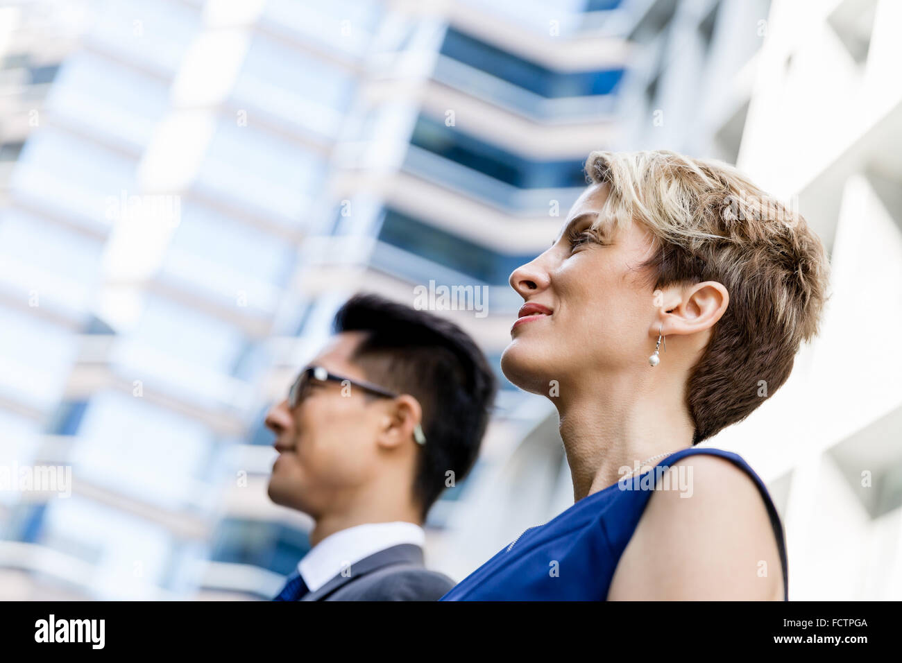 Businessteam members standing next to each other in business district ...