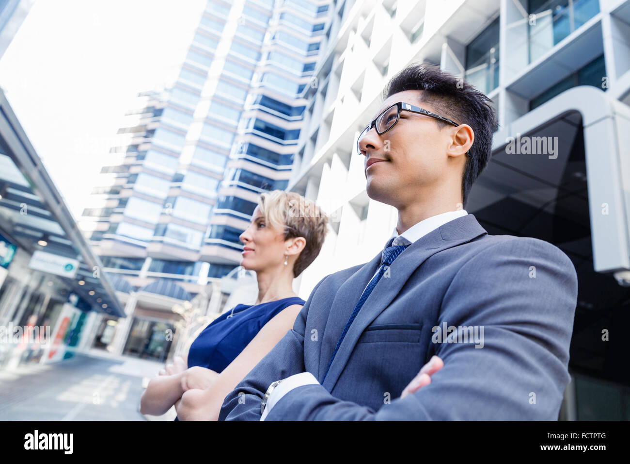 Business team members standing next to each other in business district ...