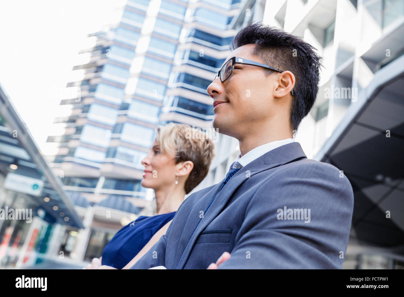 Business team members standing next to each other in business district ...