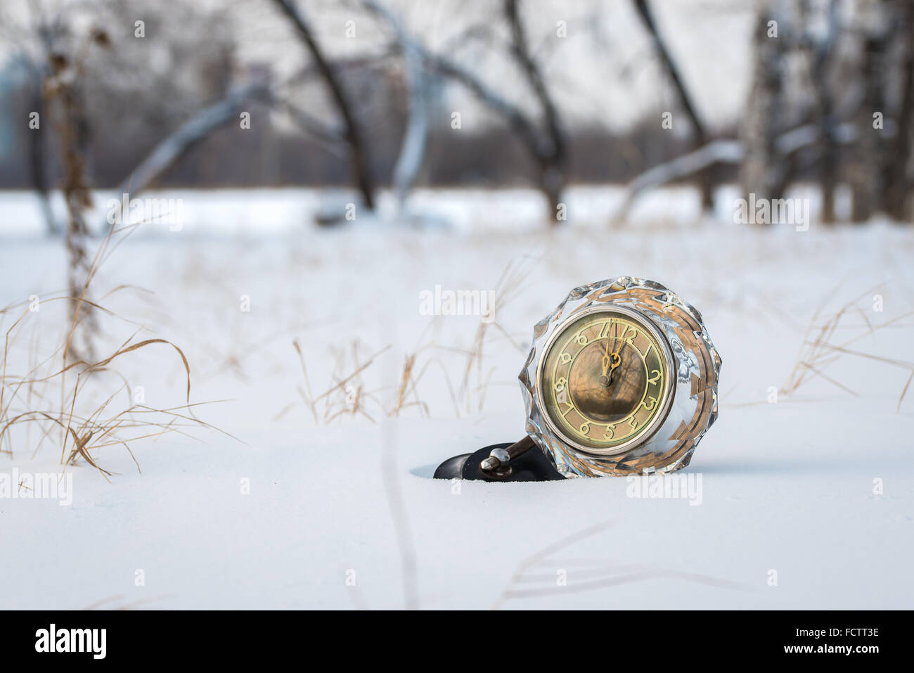 Retro clock in the snow Stock Photo - Alamy