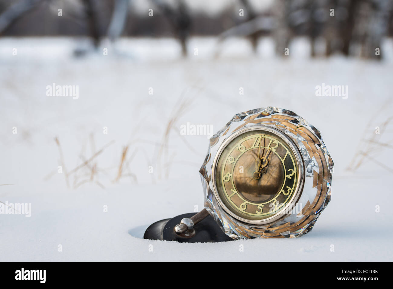 Retro clock in the snow Stock Photo - Alamy