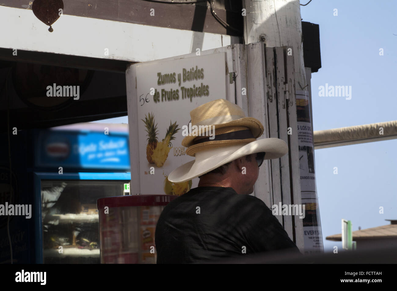 Man wearing three hats Stock Photo - Alamy