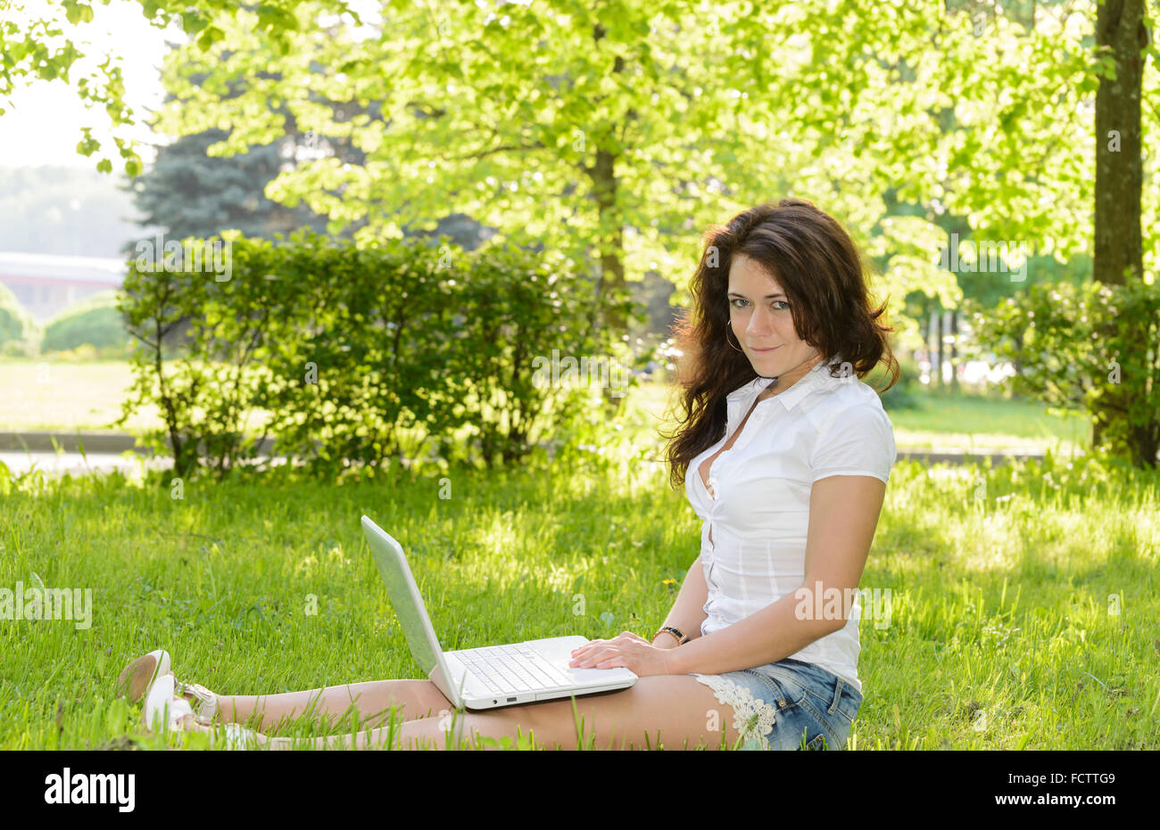 Girl student with a laptop in the park Stock Photo - Alamy