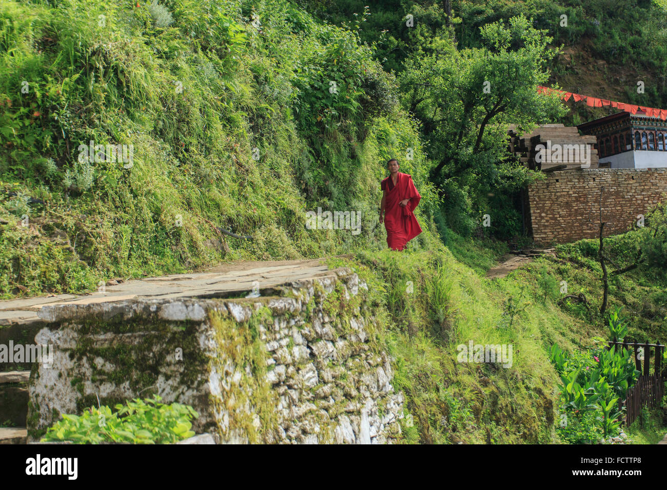 A solitary monk walks along a mountain path in Bhutan Stock Photo - Alamy