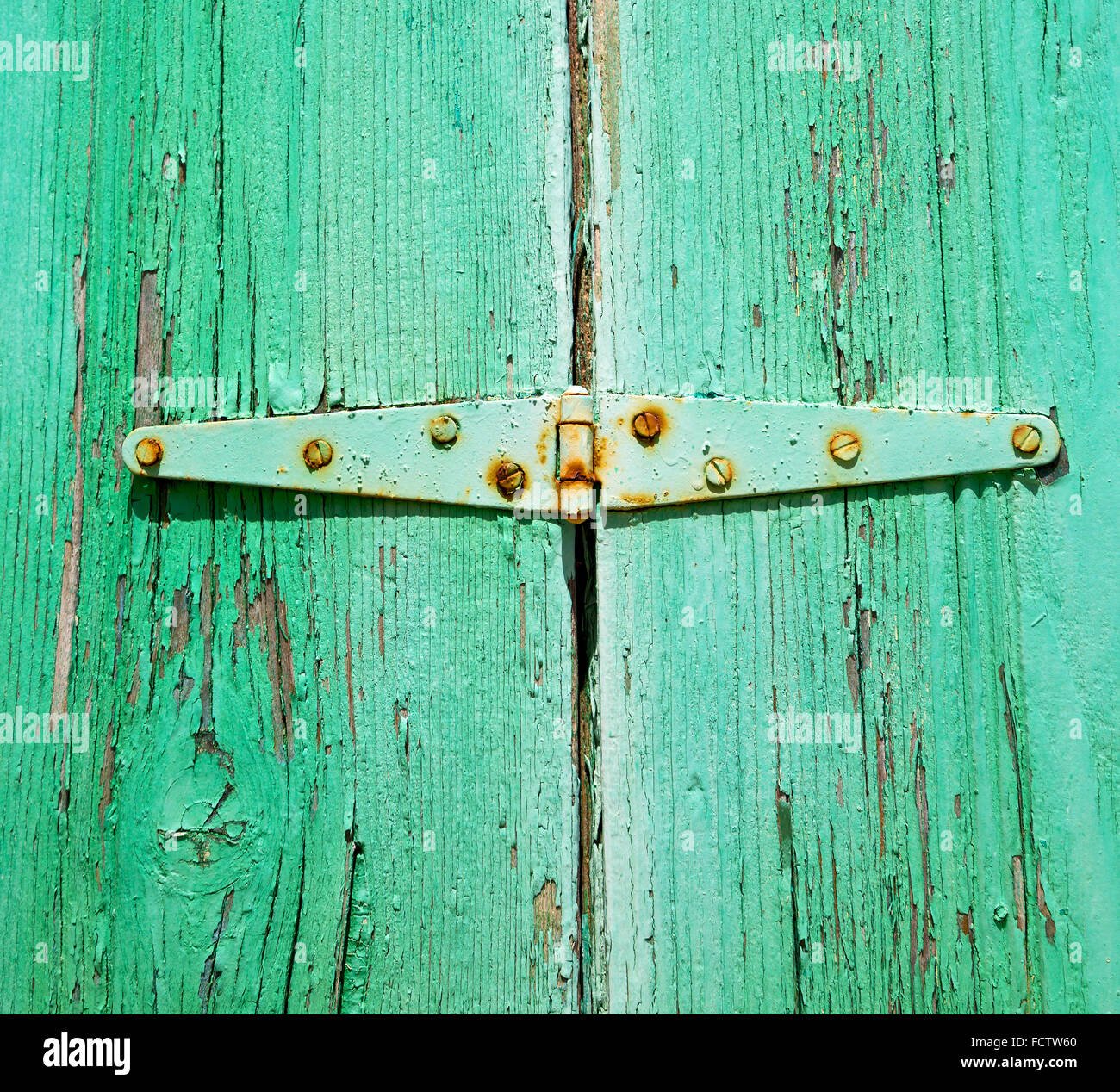 in the old wall a hinged window green wood and rusty metal Stock Photo ...