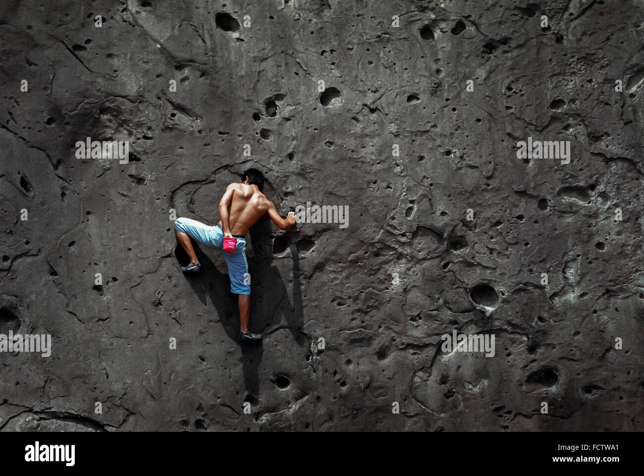 Rock climber bouldering on andesite rock face in West Java, Indonesia ...