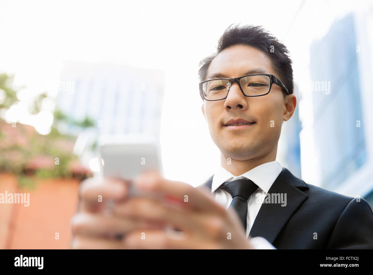 Businessman in city holding his notebook Stock Photo - Alamy