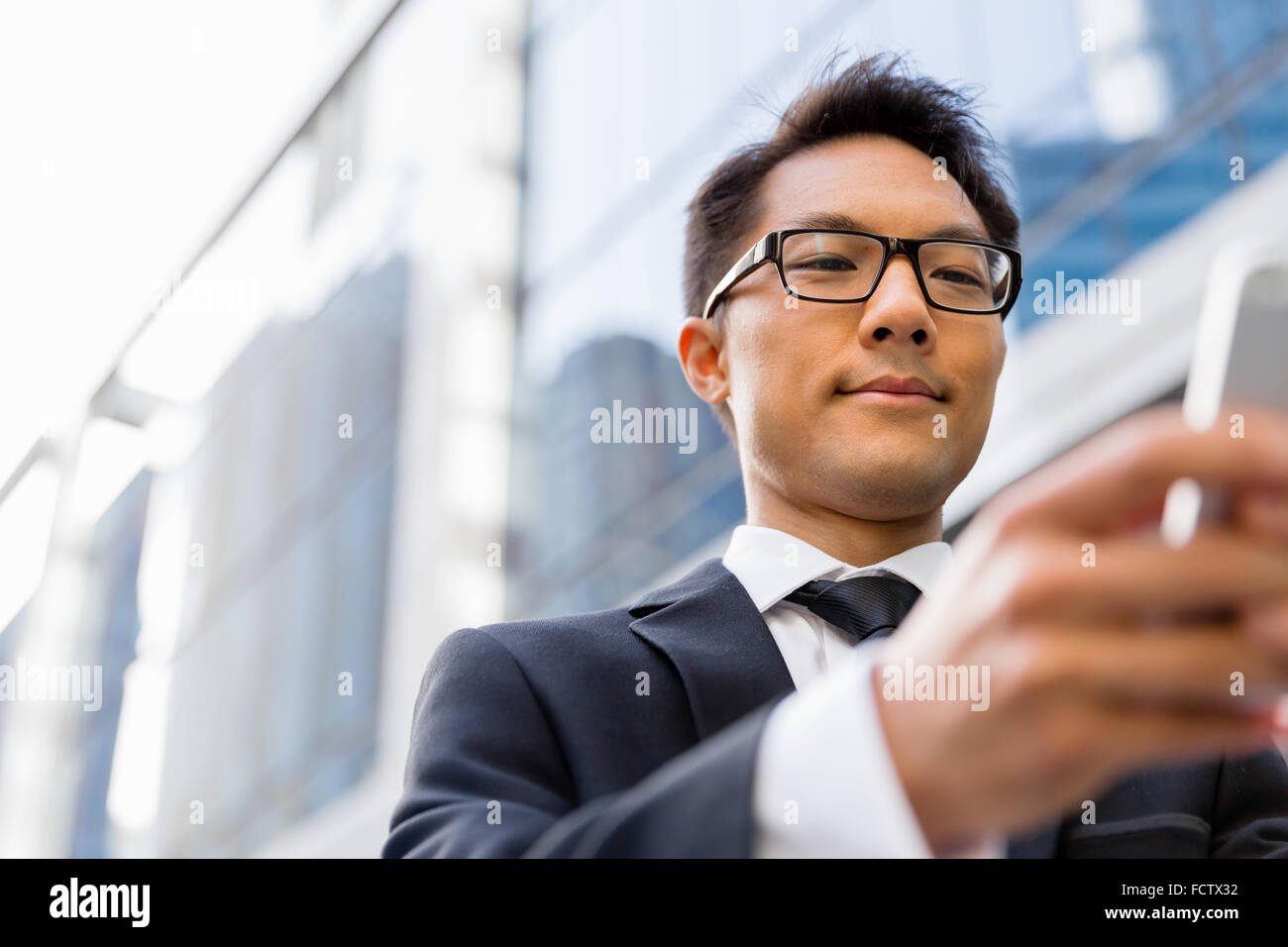 Businessman in city holding his notebook Stock Photo - Alamy