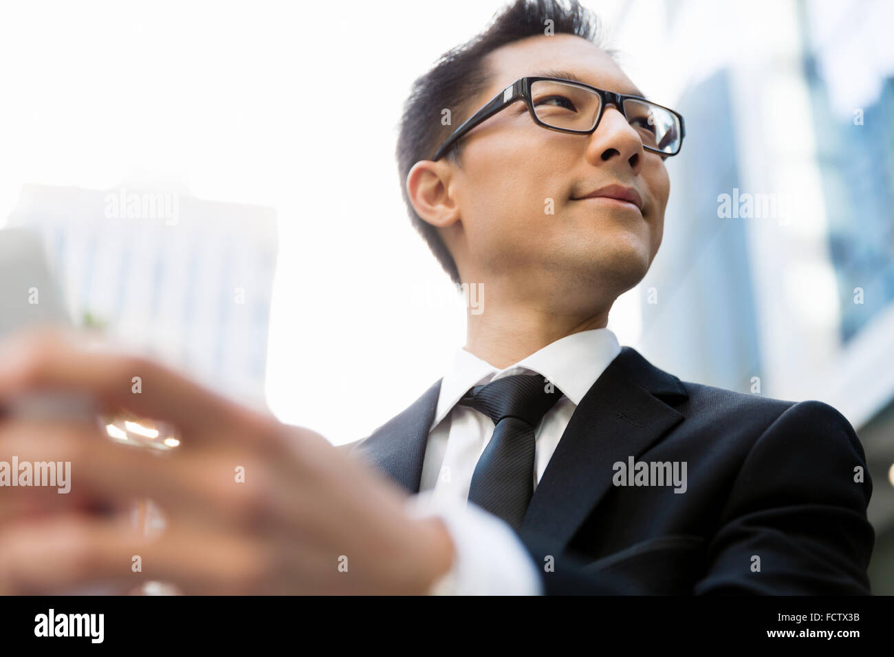Businessman in city holding his notebook Stock Photo - Alamy