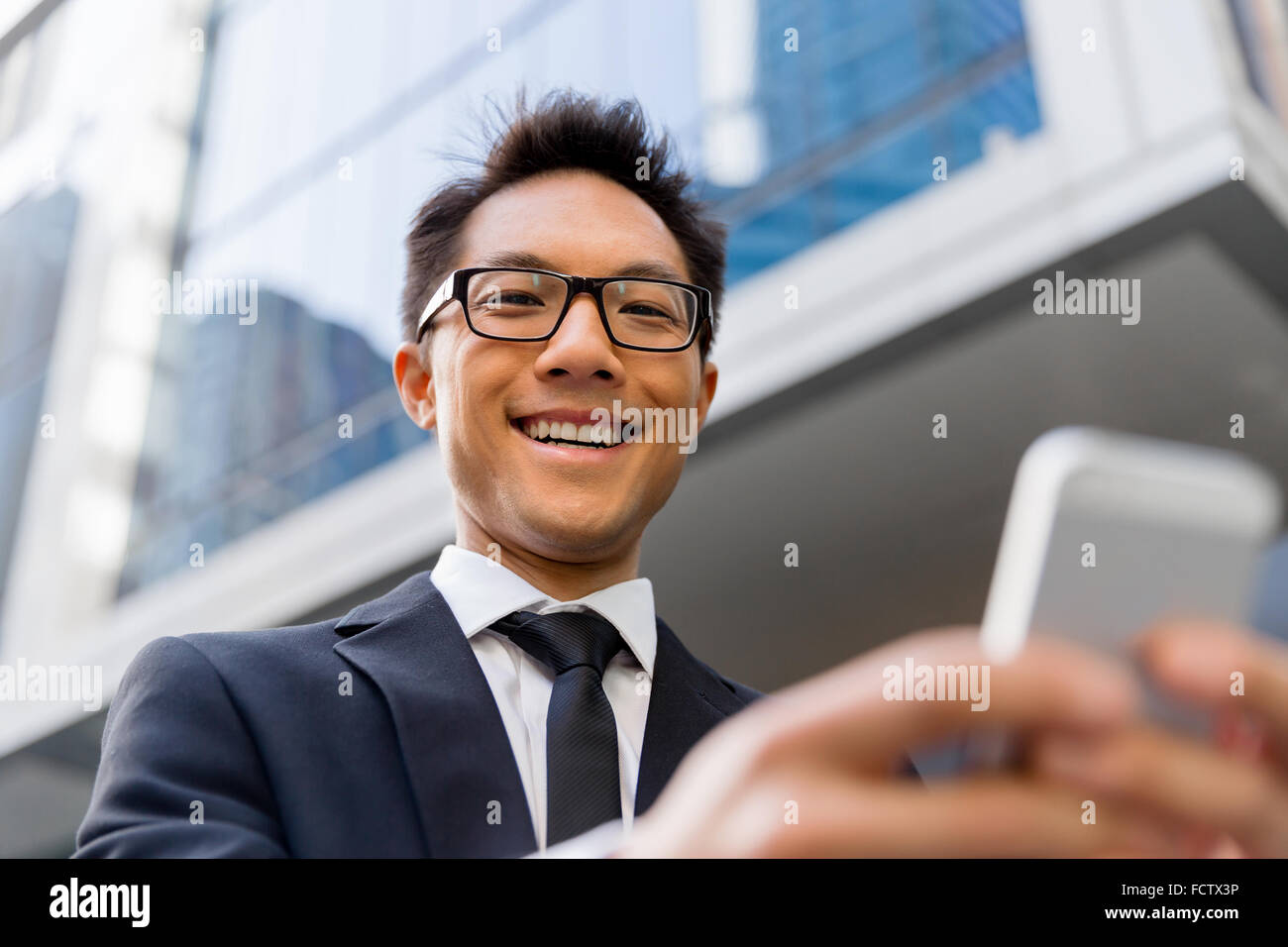Businessman in city holding his notebook Stock Photo - Alamy