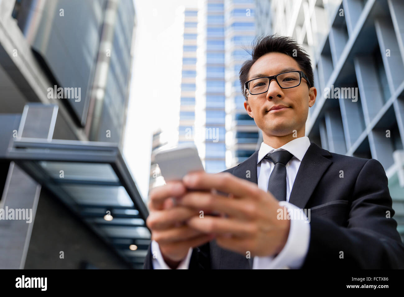 Businessman in city holding his notebook Stock Photo - Alamy