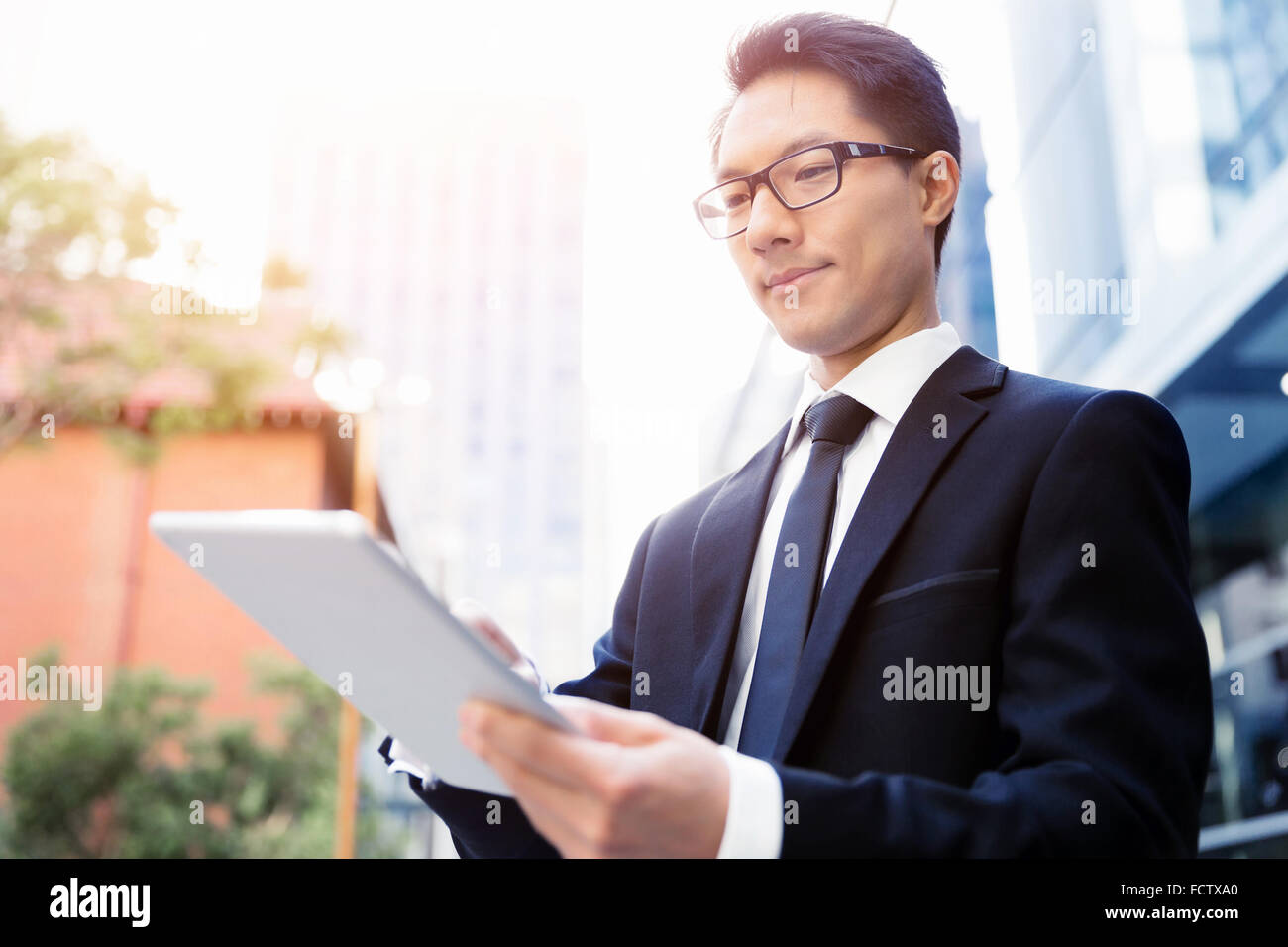 Businessman in city holding his notebook Stock Photo - Alamy