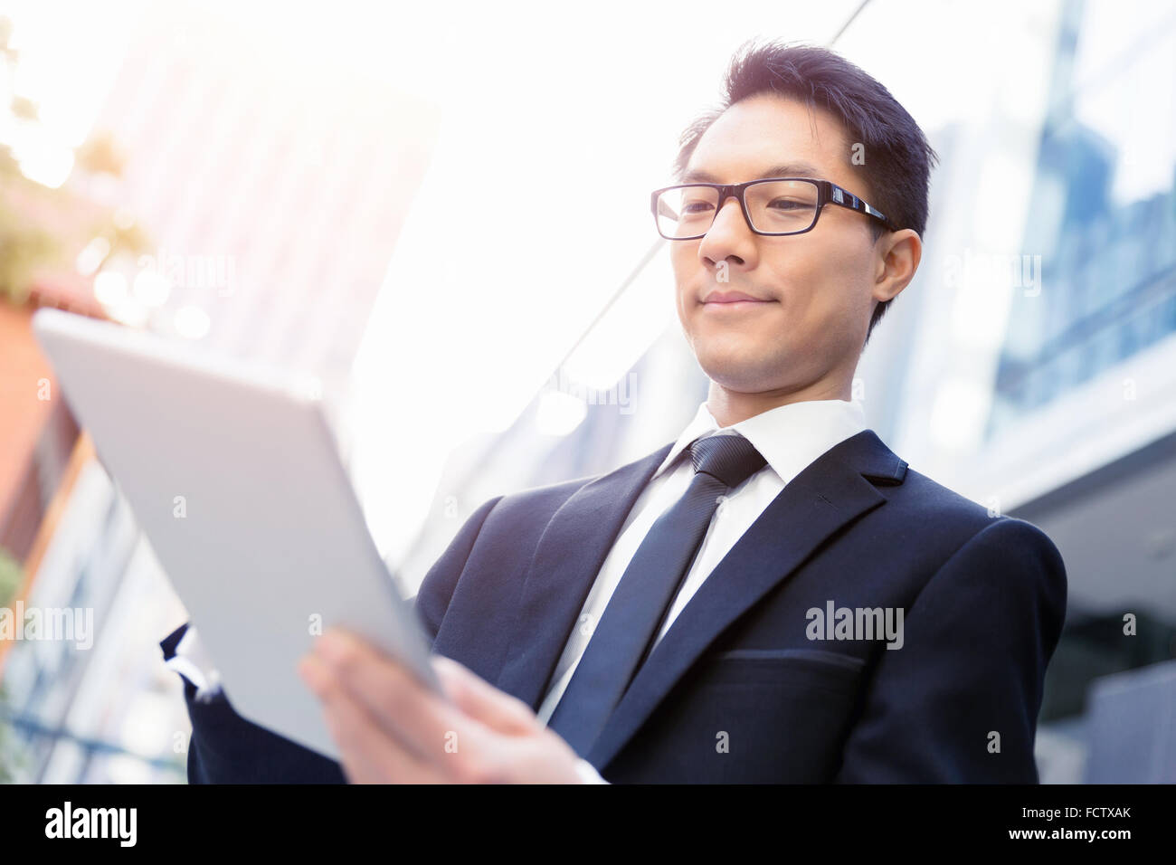 Businessman in city holding his notebook Stock Photo - Alamy