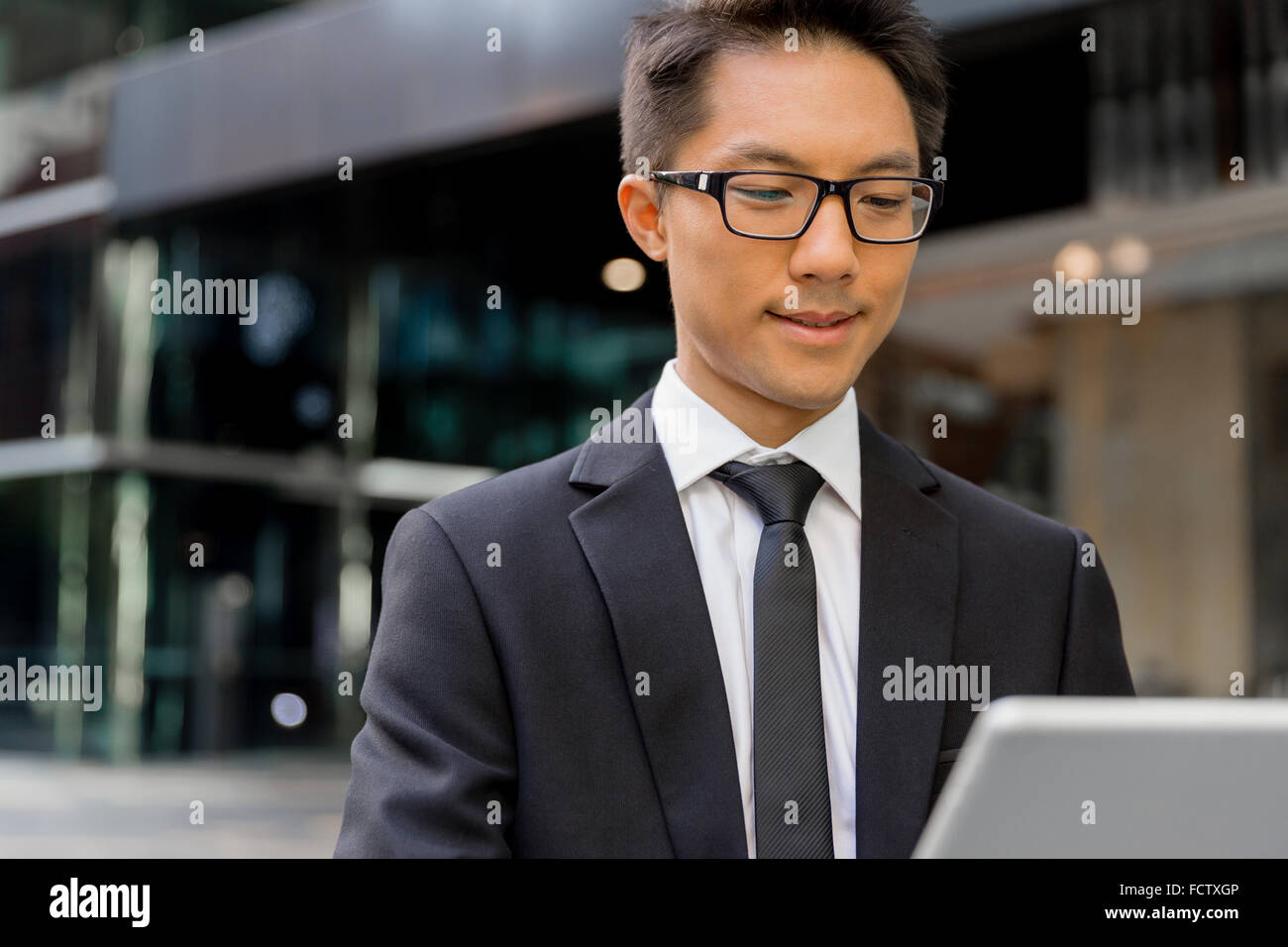 Businessman in city holding his notebook Stock Photo - Alamy