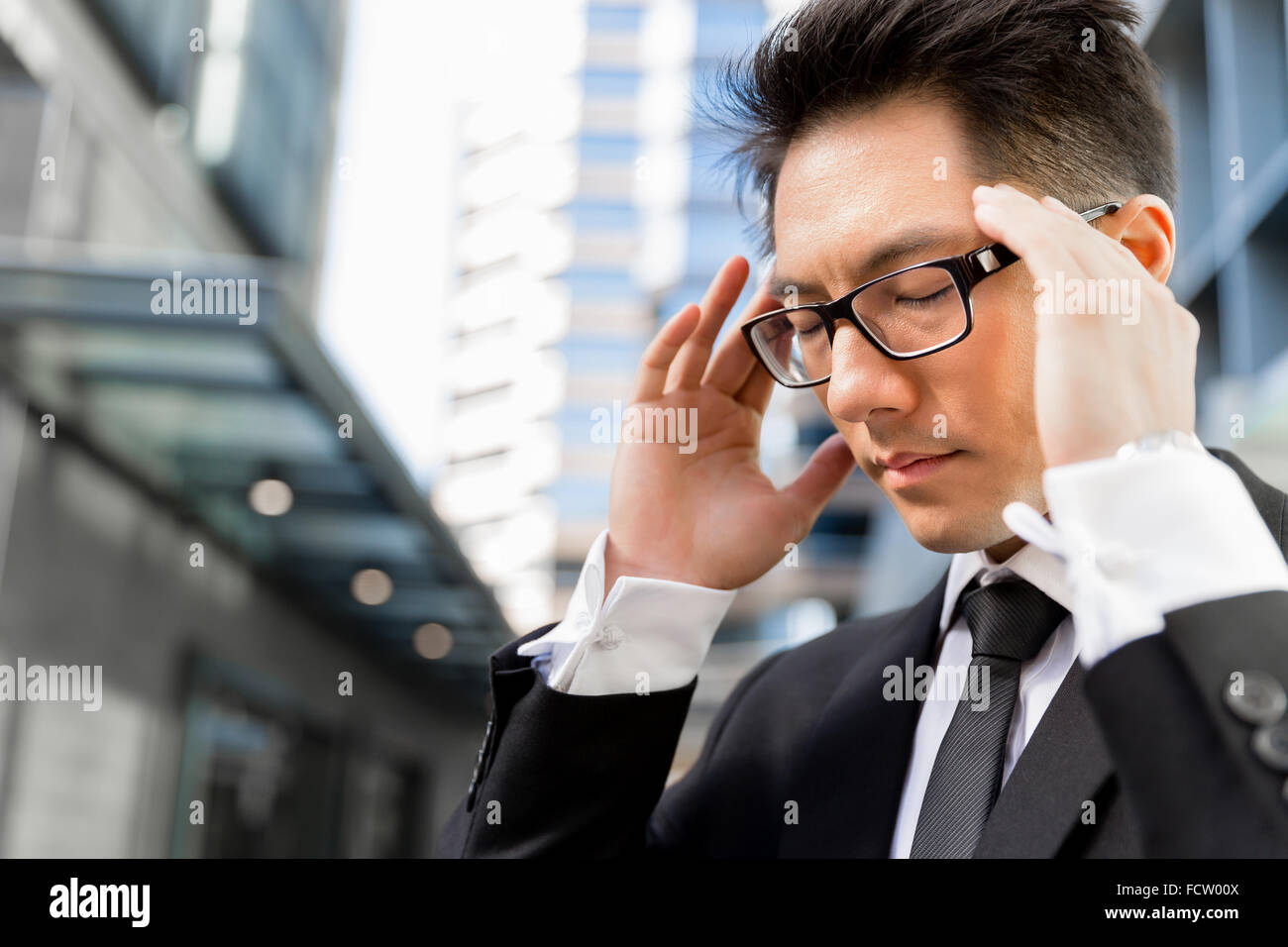 Businessman standing in street and trying to concentrate Stock Photo ...