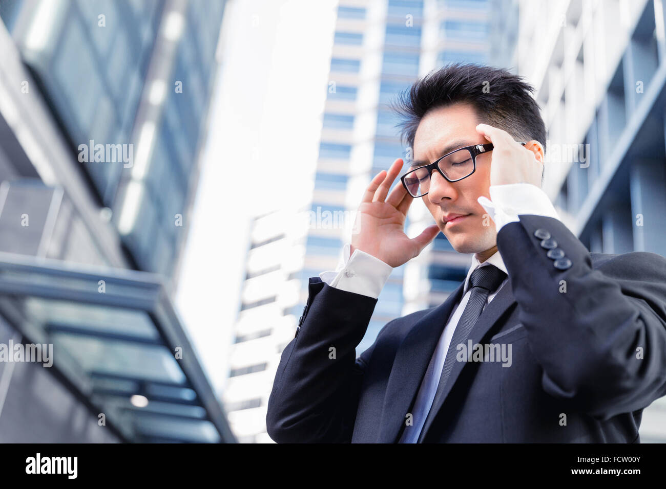 Businessman standing in street and trying to concentrate Stock Photo ...