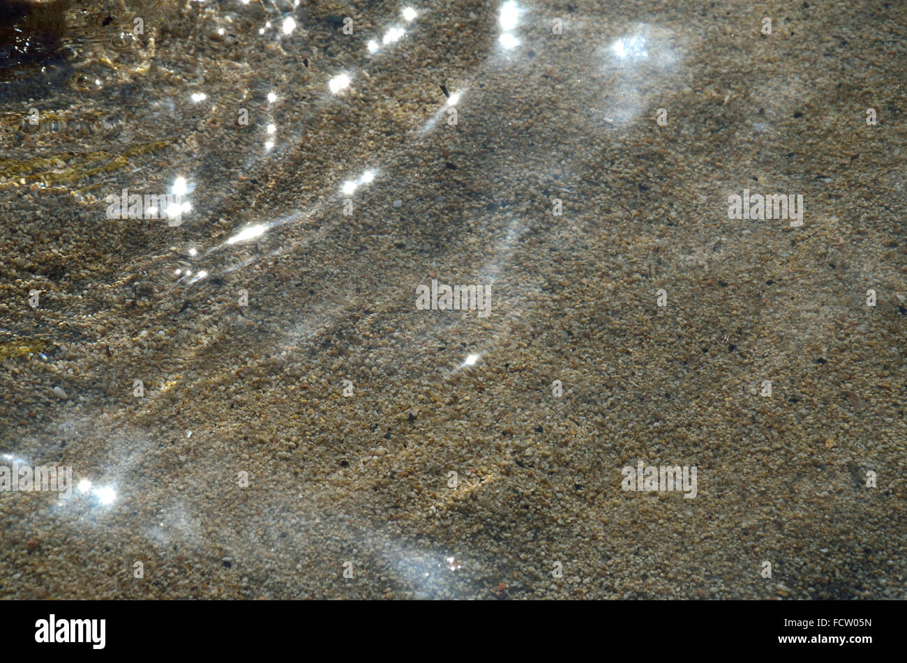 Sparkling ripple transparent sea water with seabed below Stock Photo ...