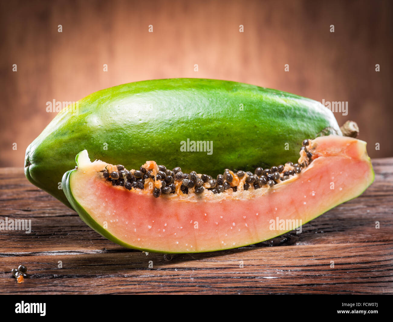 Papaya fruit on wooden background Stock Photo - Alamy