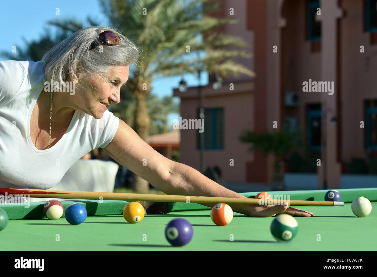 Mature woman Playing pool Stock Photo - Alamy