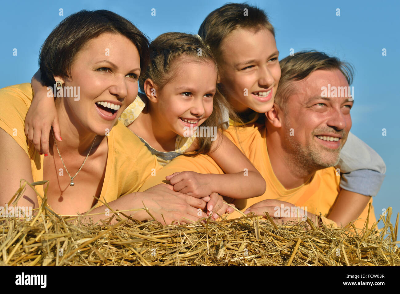 happy family at field Stock Photo - Alamy