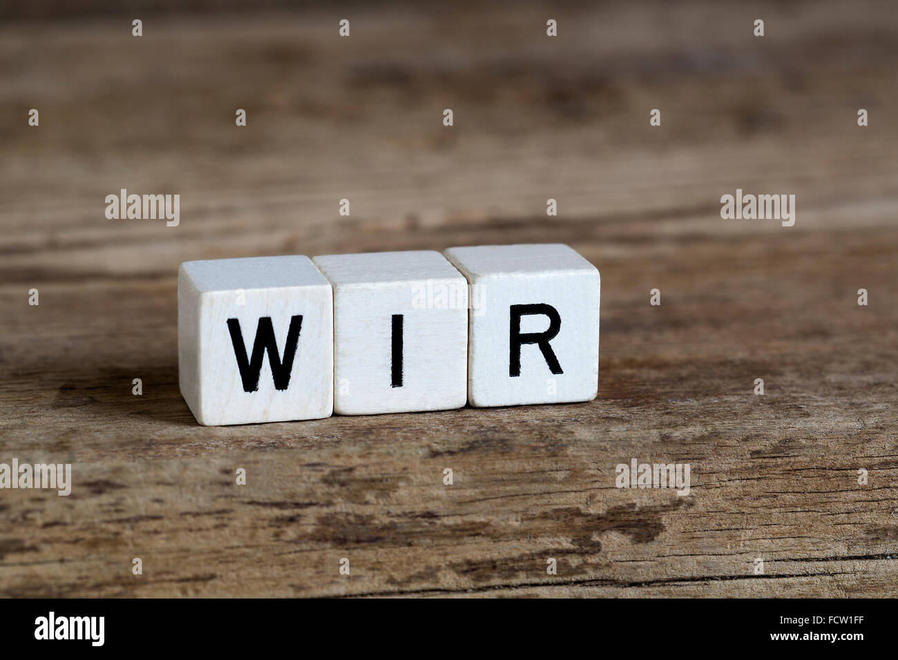 German word wir written in cubes on wooden background Stock Photo - Alamy