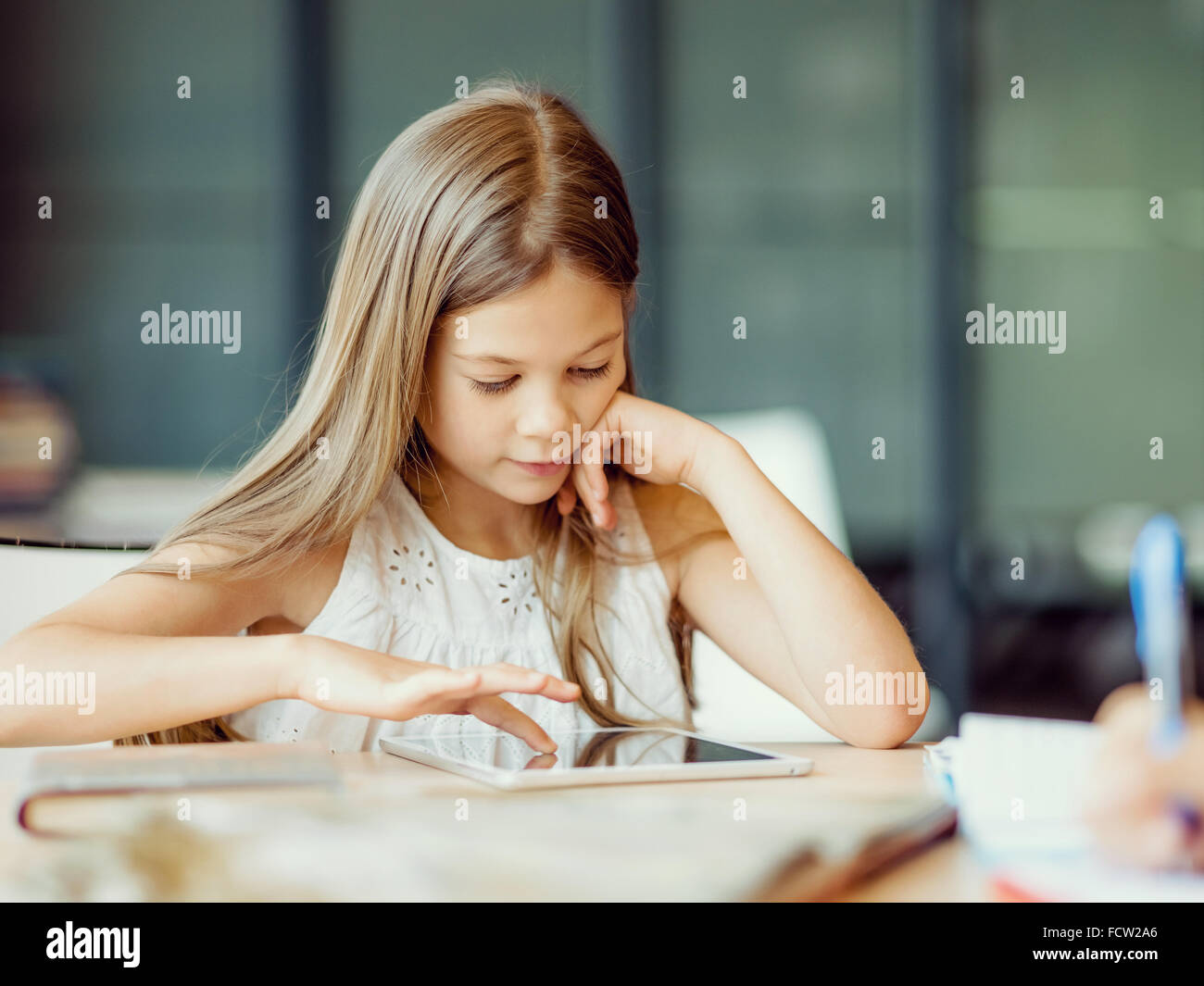 Girl doing her homework in library Stock Photo - Alamy