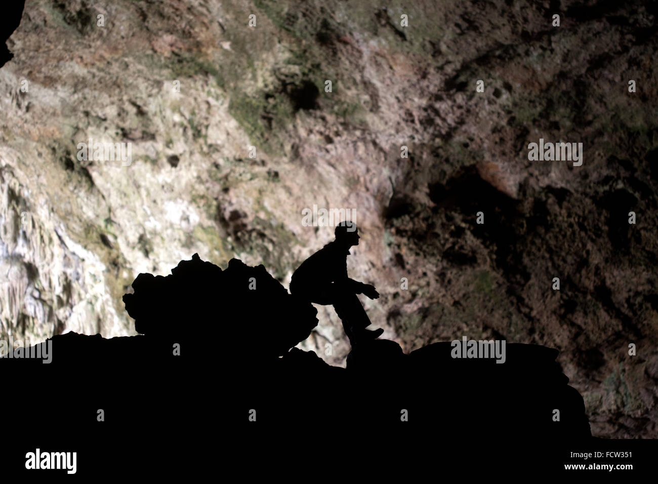 A woman sits in Rio Frio cave in Mountain Pine Ridge, Cayo, Belize ...