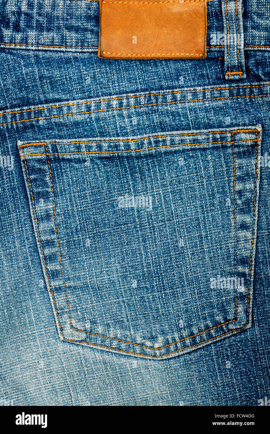Blue jeans fabric with back pocket and a label background Stock Photo ...